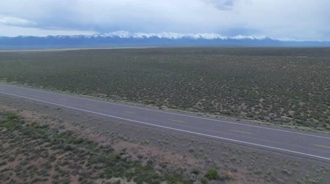 Flying Sideways Along Desert Road and Sn... | Stock Video | Pond5