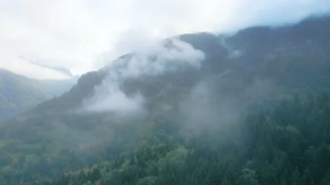 Flying through mist and clouds in mounta... | Stock Video | Pond5
