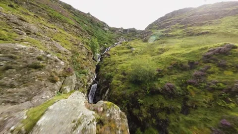 Flying up a water fall in Wales - light ... | Stock Video | Pond5
