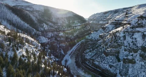 Flyover above narrow valley and two way ... | Stock Video | Pond5