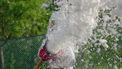 Foam flies out of the fire hose in a jet... | Stock Video | Pond5
