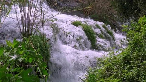 Foaming waterfall flowing down over rock... | Stock Video | Pond5
