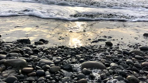 Foamy Waves Crash Over Pebbles On Beach ... | Stock Video | Pond5