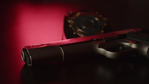 Focus rack from police badge to pistol w... | Stock Video | Pond5