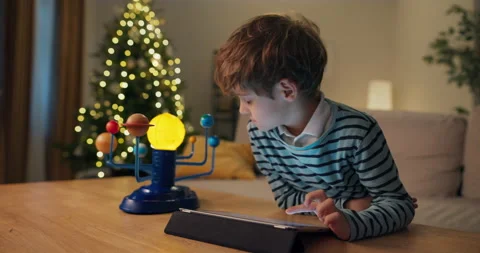 Focused boy with brown hair explores the... | Stock Video | Pond5