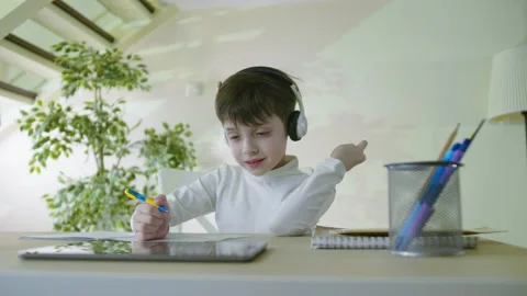 Focused Cute School Boy Studying at Tabl... | Stock Video | Pond5
