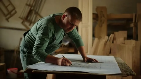 Focused man making drawings for wooden p... | Stock Video | Pond5