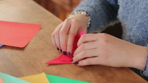 Folding Origami paper craft on the table... | Stock Video | Pond5