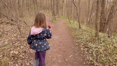 Following a little girl walking along a ... | Stock Video | Pond5