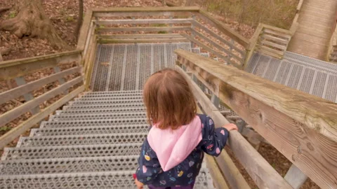 Following a little girl walking down an ... | Stock Video | Pond5