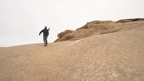 Following man running through the desert... | Stock Video | Pond5