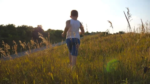 Following to young unrecognizable boy ru... | Stock Video | Pond5