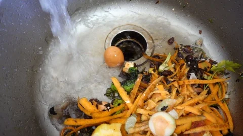 Food waste in the kitchen sink. Grinder ... | Stock Video | Pond5