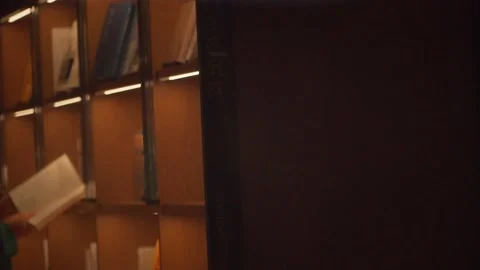 Footage of a wooden shelf with books in ... | Stock Video | Pond5