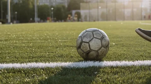 Football player pushes old ball with his... | Stock Video | Pond5