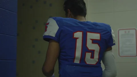 Football Player Walking Out of the Locke... | Stock Video | Pond5