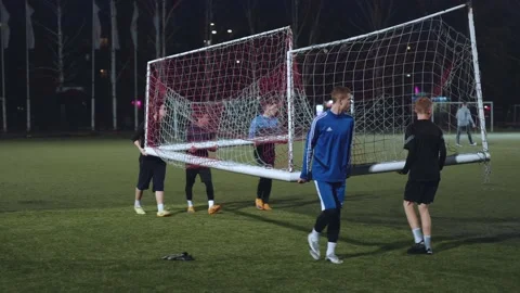 Football players carry the goal, guys ca... | Stock Video | Pond5