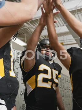 Football Players Celebrating In Locker Room - Stock Image - Everypixel