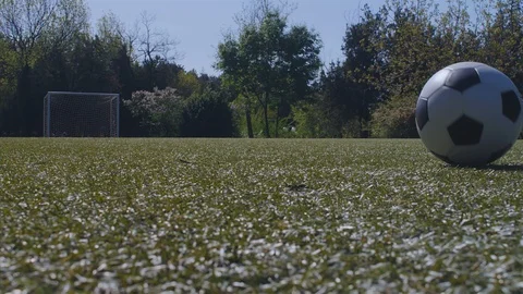 Football soccer ball rolling slowly on f... | Stock Video | Pond5