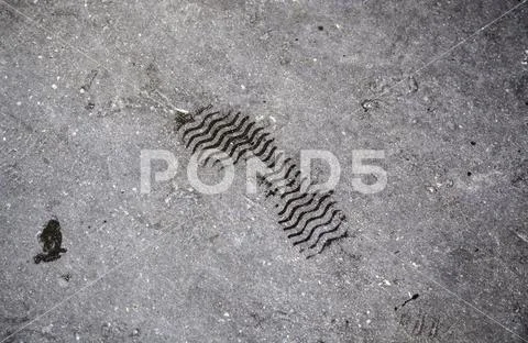 Photograph: Footprints in urban floor mud, symbol and texture #128482417