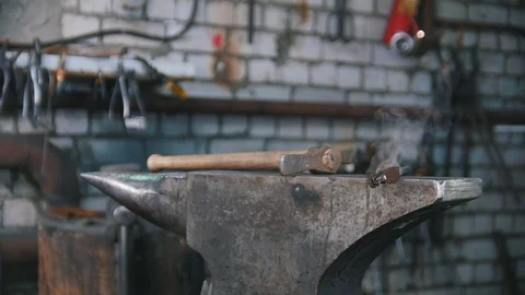 A forceps and a hammer laying on the anv... | Stock Video | Pond5