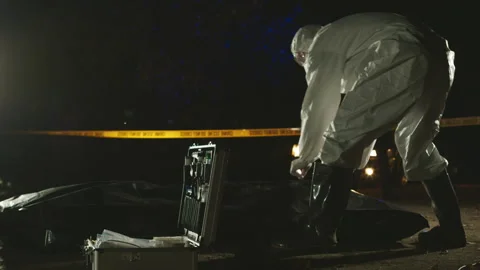 Forensic Expert Examining Dead Body at N... | Stock Video | Pond5