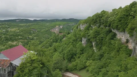 forest covered gorge and house on a rock... | Stock Video | Pond5