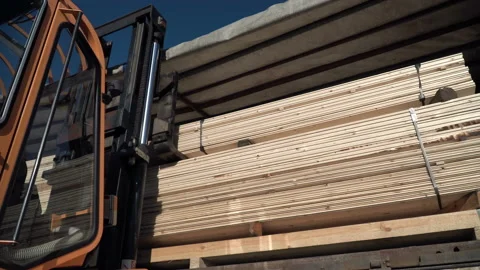 forklift is loading wood planks into the... | Stock Video | Pond5