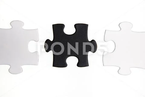 Formation of white puzzle pieces and one black piece ~ Hi Res #172079858