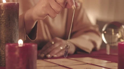 Fortune Teller with Pendulum over Spread... | Stock Video | Pond5