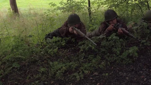 Four American soldiers firing prone behi... | Stock Video | Pond5