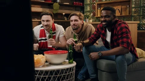Four football fans are rooting for their... | Stock Video | Pond5