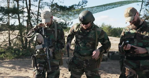 Four men stand guard soldiers dressed in... | Stock Video | Pond5