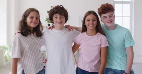 Four smiling classmates standing togethe... | Stock Video | Pond5