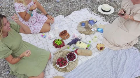 Four smiling women at a picnic by the se... | Stock Video | Pond5