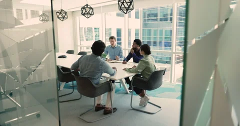 Four teammates gather in conference room... | Stock Video | Pond5
