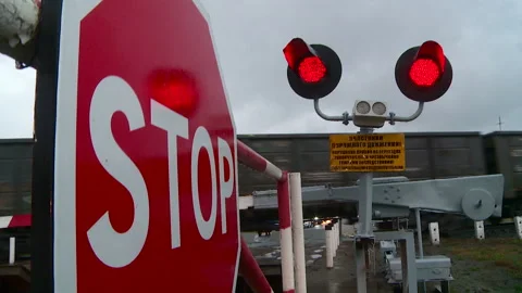 a freight train at a railway crossing in... | Stock Video | Pond5