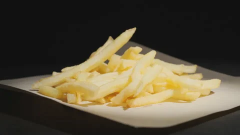 French fries rotating on table on black ... | Stock Video | Pond5