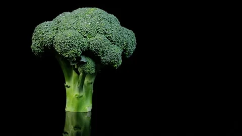Fresh green broccoli rotating on a black... | Stock Video | Pond5