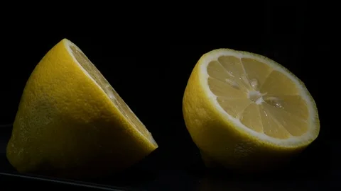Fresh lemon cut fruit gyrating with blac... | Stock Video | Pond5