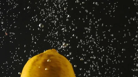 Fresh lemon falling into the water with ... | Stock Video | Pond5