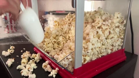Fresh popped pop corn being scooped in r... | Stock Video | Pond5