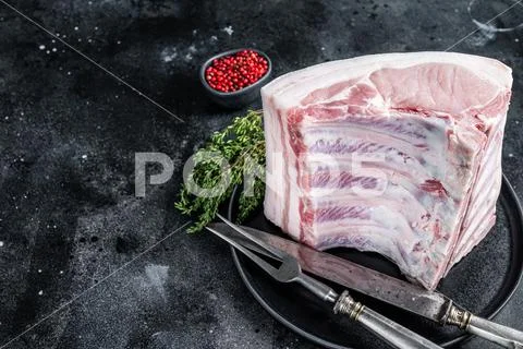 Fresh Raw whole rack of pork loin chops with ribs on a plate with meat ...