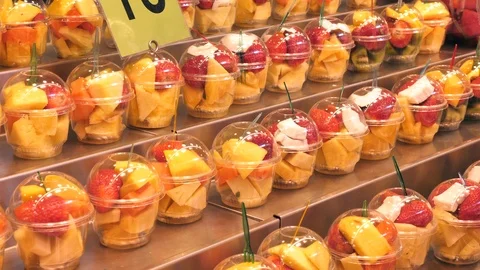 Fresh sliced fruit in plastic cups on a ... | Stock Video | Pond5