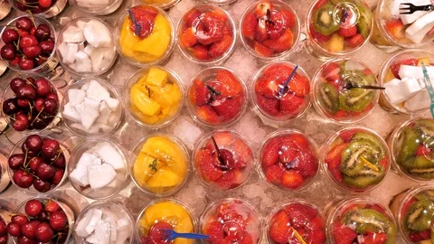 Fresh sliced fruit in plastic cups on a ... | Stock Video | Pond5