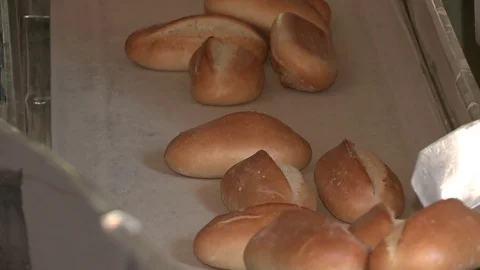 Freshly baked bread moving along the con... | Stock Video | Pond5