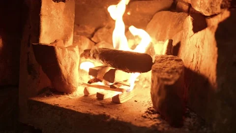 A freshly lit log fire gives out an oran... | Stock Video | Pond5