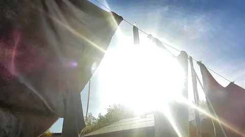 freshly washed clothes hang in the sun o... | Stock Video | Pond5