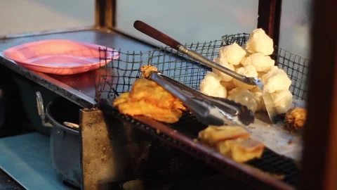 Fried food in a display case sold on the... | Stock Video | Pond5