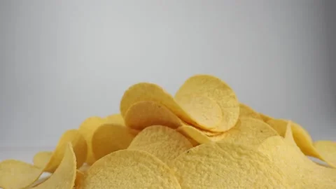 Fried potato chips rotating on a white b... | Stock Video | Pond5